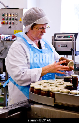 Factory worker checking jars Stock Photo - Alamy