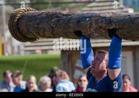 Strongman lifting log at Galloway Gathering Stock Photo - Alamy