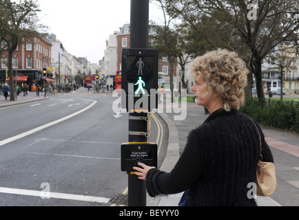 Pedestrian Puffin Crossing with traffic light on green with pedestrian ...