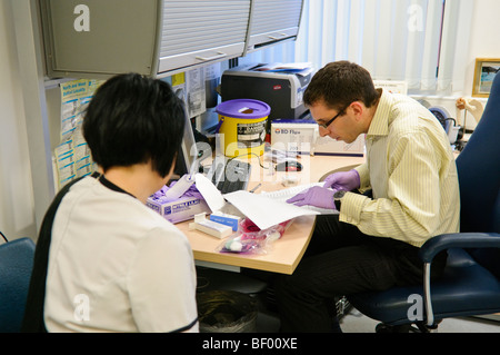 Consultation room in a doctors surgery with desk and chairs Stock Photo ...