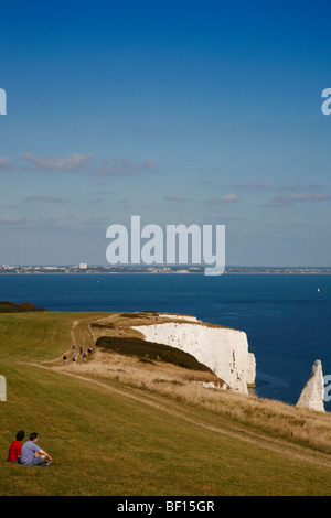 Walkers taking a rest beside the cliff top footpath above Old Harry ...