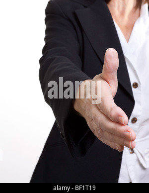 Older senior business woman's arthritic hand with knobbly fingers in a ...