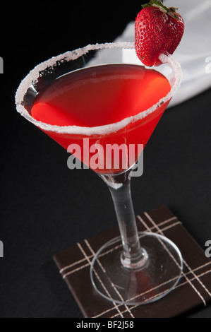 A vertical shot of strawberry cocktail, a glass filled with Christmas ...