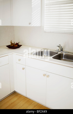 Kitchen with stainless steel sink, serving hatch and blue countertop ...