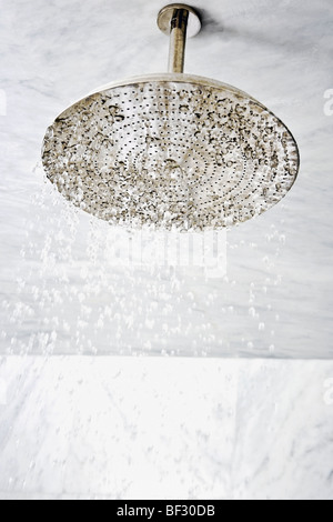 Dripping water from a modern faucet in a bathroom highlights the issue ...