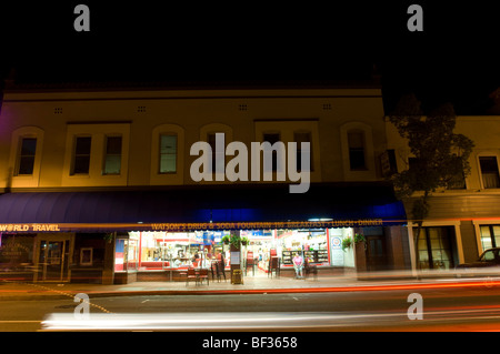 A nighttime photograph of an old fashioned 50s style drug store located ...