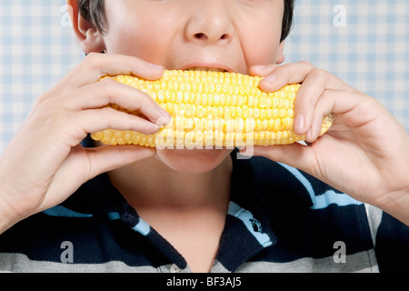 Boy eating sweet corn Stock Photo - Alamy