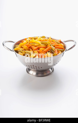 Multi colored rigatoni pasta in a strainer Stock Photo - Alamy