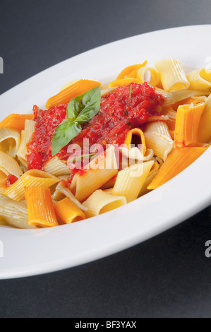 Dish of rigatoni pasta topped with tomato concasse Stock Photo - Alamy
