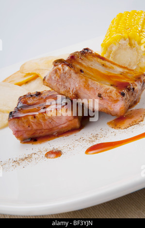 Spare ribs served on a white plate Stock Photo - Alamy
