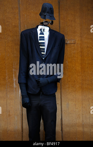 Street performer dressed as invisible man standing and giving a thumbs ...