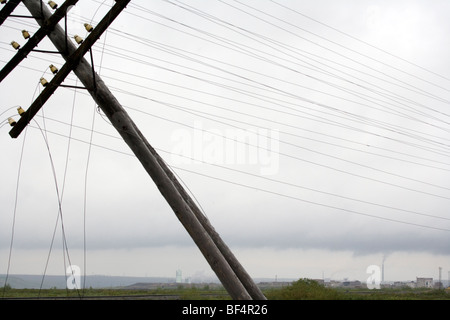 Fallen telegraph pole with industrial buildings and smoke stacks on ...