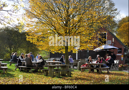 People sat outside cafe at Hatton Locks in autumn, Grand Union Canal ...
