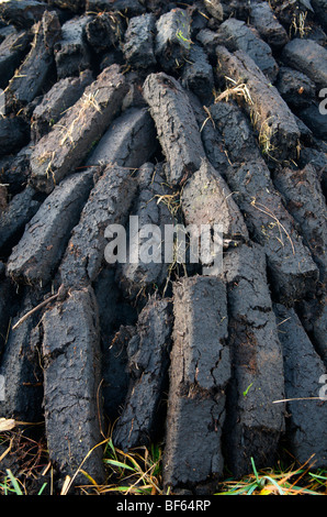 piles of irish peat turf fuel drying in the landscape Stock Photo - Alamy