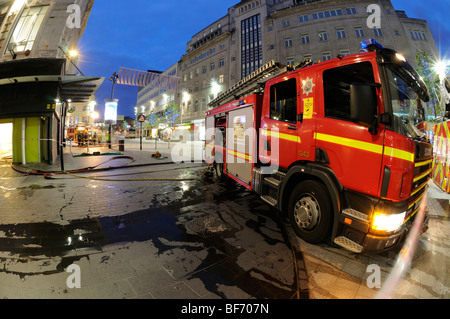 Fisheye view of fire engines at large building fire at night Stock ...