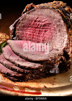Irish roast beef joint with garlic Stock Photo - Alamy