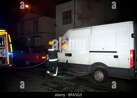 White transit van on fire at night with flames from cab Stock Photo - Alamy