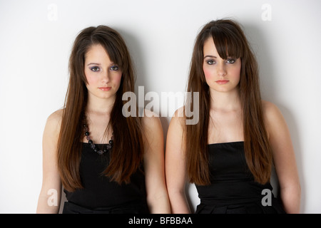 Identical teenage female twins dressed alike in same clothing outfits ...
