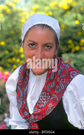 Portrait of basque girl in traditional clothing standing in the doorway ...
