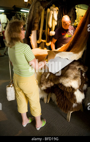 Stalls selling furs and skins in market on busy Krupowki Street ...