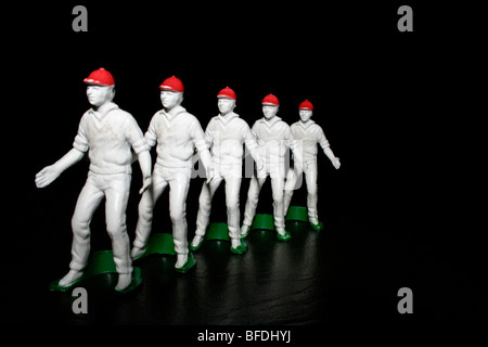 Toy men playing cricket on black background Stock Photo - Alamy