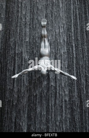 Waterfall with a art sculpture of human diving inside the shopping ...