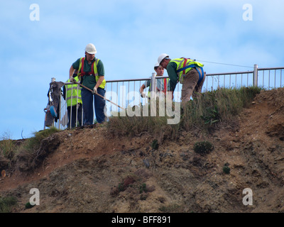 a workman working at height wearing an high visibility vest without any ...