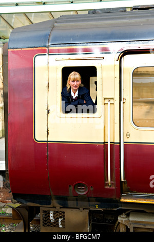 Female train driver in uniform checks her schedule before entering the ...
