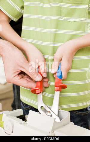 boy playing fixing toy car as mechanic in his bedroom Stock Photo - Alamy