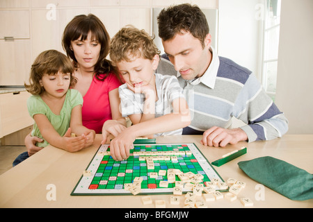 Four young people playing scrabble Stock Photo - Alamy