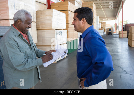 Men stock-taking in warehouse Stock Photo - Alamy