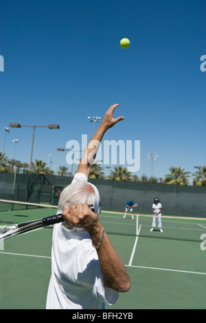 Man hitting a tennis ball back Stock Photo - Alamy