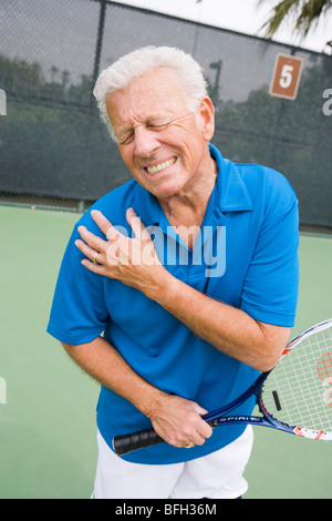 Tennis player suffering from shoulder injury Stock Photo - Alamy