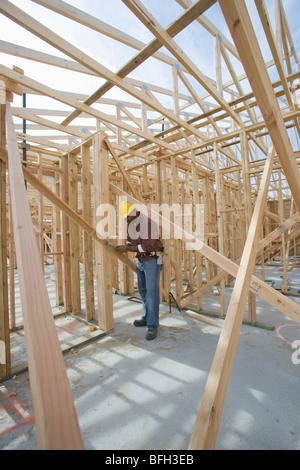 Construction Worker Checking Level of Wooden Structure Stock Photo - Alamy