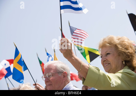 Crowd holding up National flags Stock Photo - Alamy
