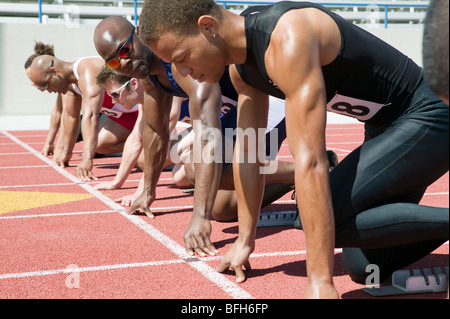 Male sprinters in starting blocks Stock Photo - Alamy