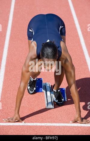 Female athlete in starting block, ready to run Stock Photo - Alamy