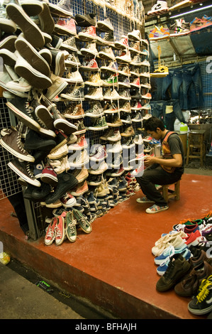 tourist shopping for shoes at the Chatuchak Weekend Market in Bangkok ...