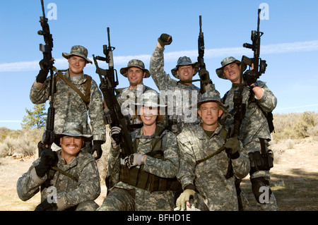 Army soldier cheering with arms raised Stock Photo - Alamy