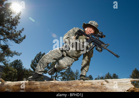 Soldier jumping over log Stock Photo - Alamy