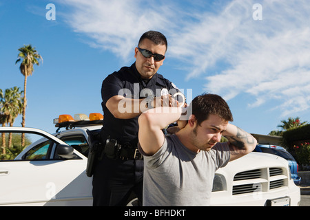 Police Officer Arresting Young Man Stock Photo - Alamy