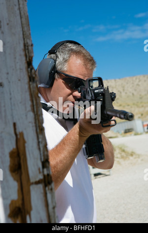 Man aiming machine gun at firing range, close up of hands Stock Photo ...
