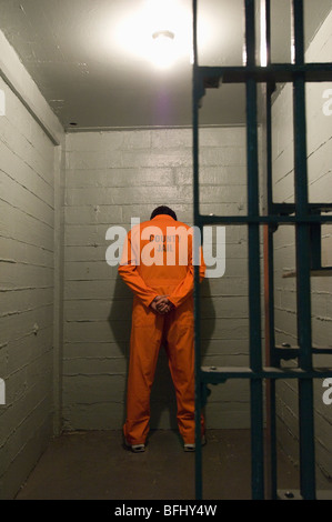 A prisoner standing behind his prison cell bars Stock Photo - Alamy