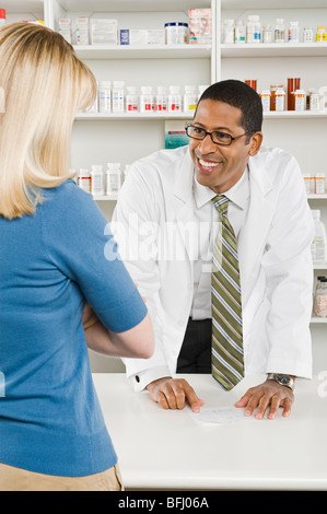 African american women pharmacist and customer speaking at pharmacy ...