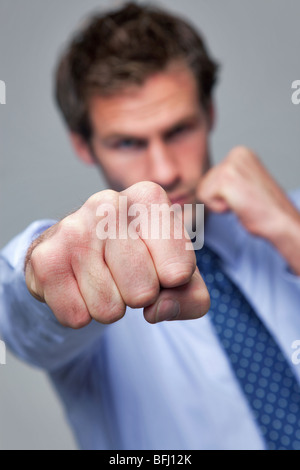 Adult male throwing a punch towards the camera giving the impression ...