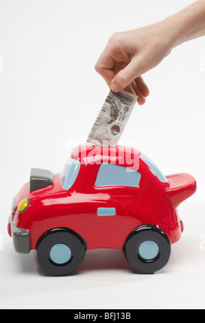 Hand putting banknote into money box Stock Photo - Alamy