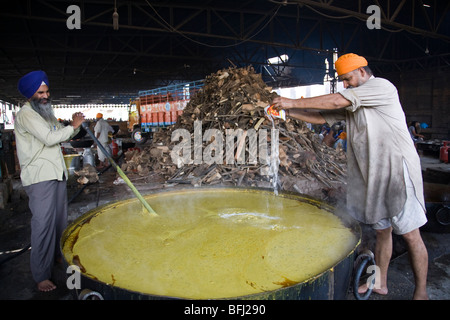 Sikh men cooking dhal (curried lentils) on a huge pot. The Golden ...