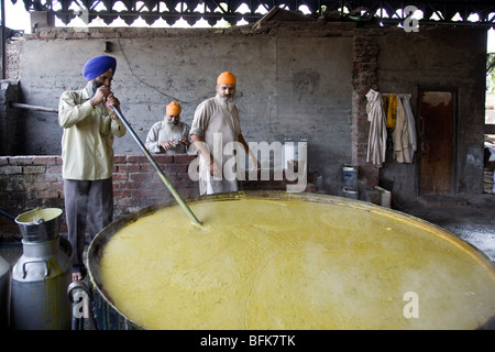Sikh men cooking dhal (curried lentils) on a huge pot. The Golden ...
