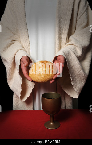Jesus hands holding bread and wine with tray of grapes in background ...