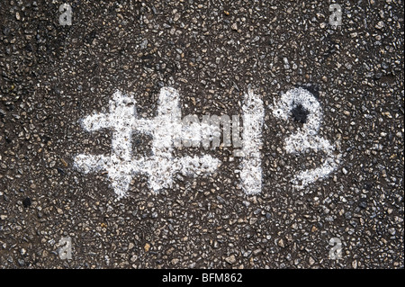Painted number 13 on tarmac car park / parking lot space. Bad luck and ...